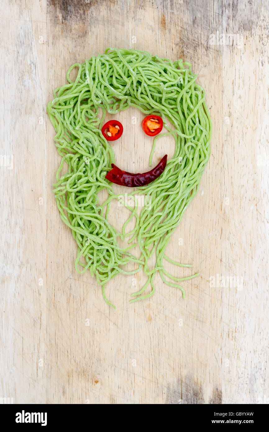 smile faces on wood background made from vegetable and noodle with ...