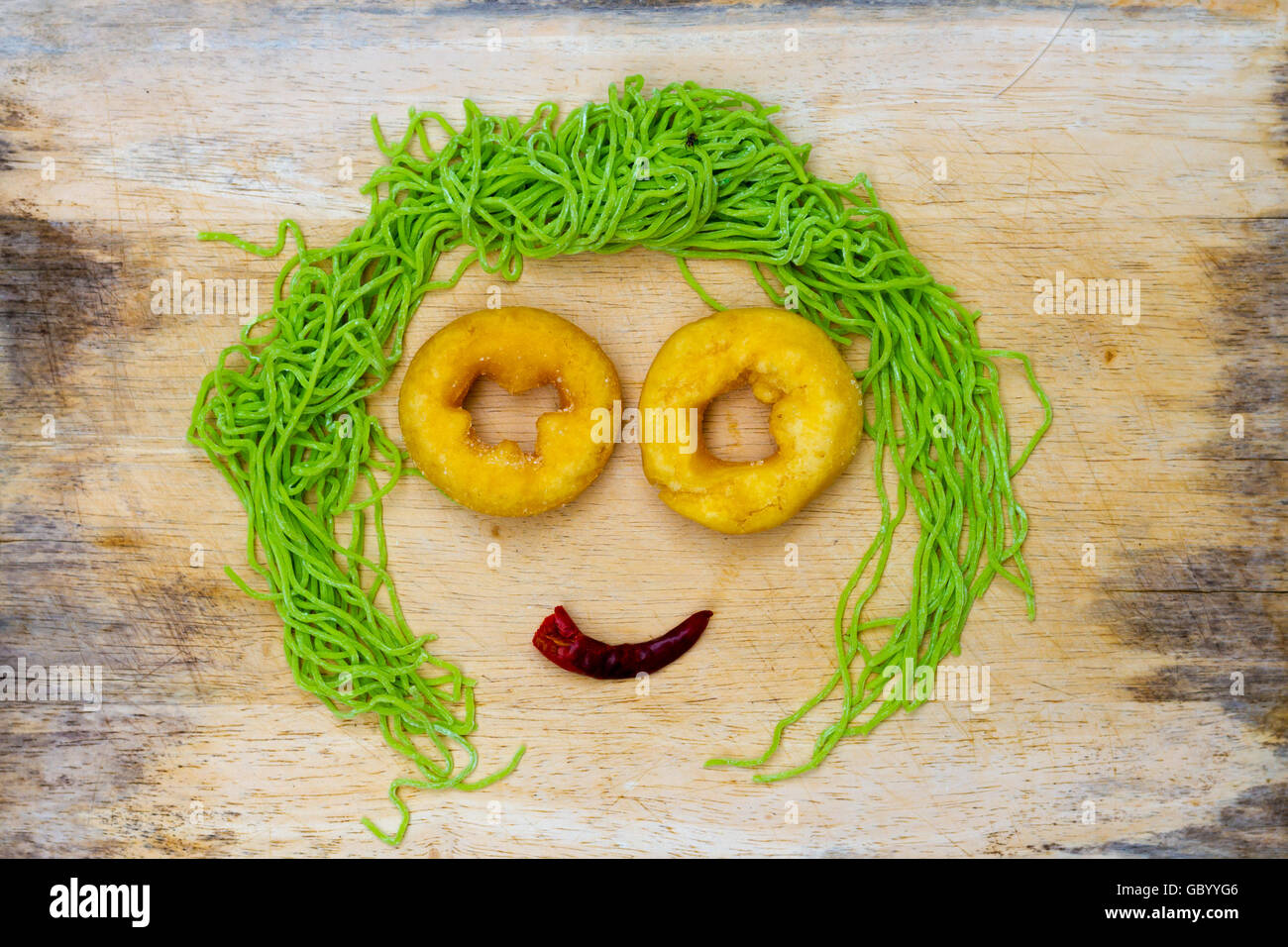 smile faces on wood background made from vegetable and noodle with ...