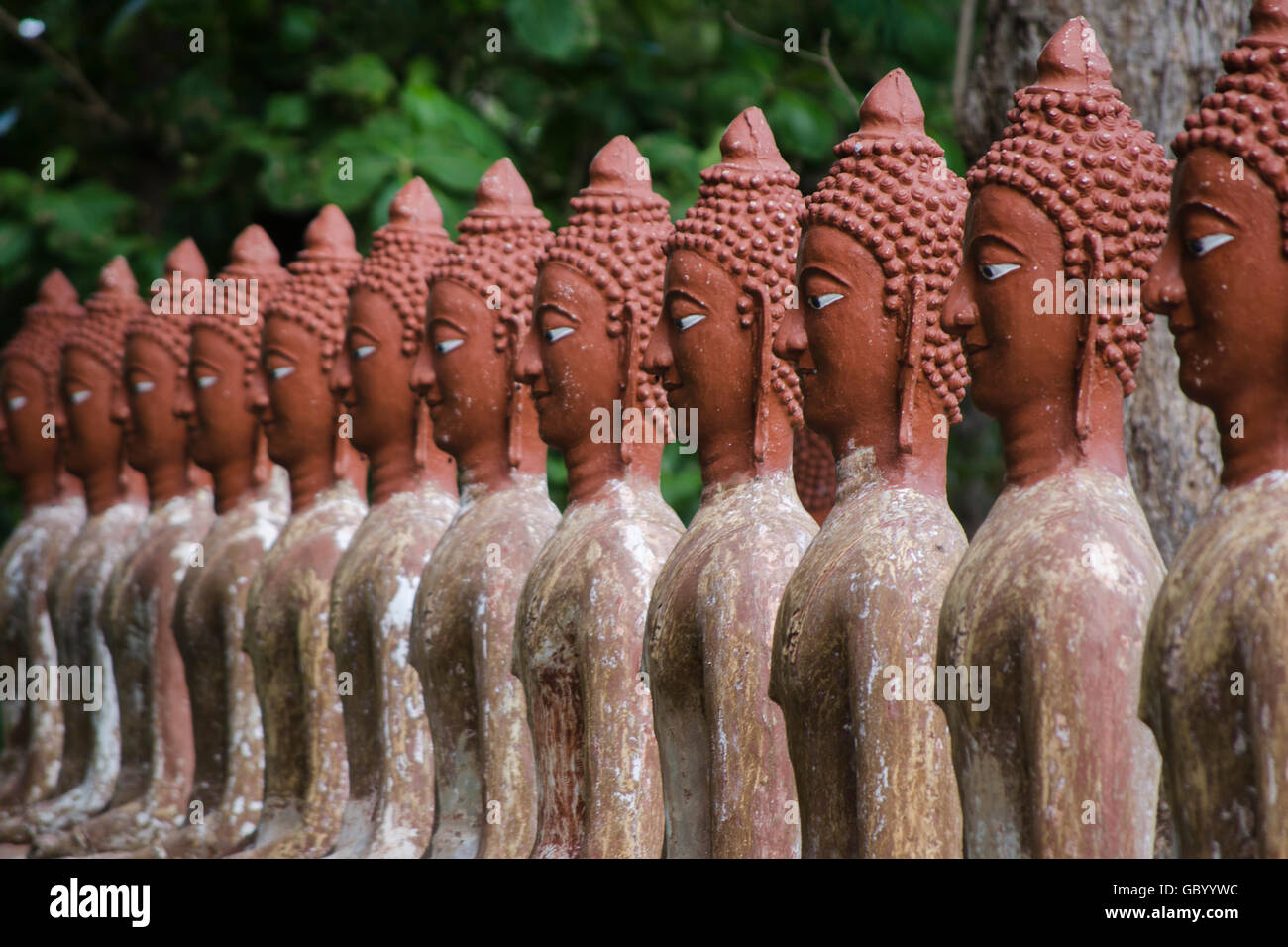 Ancient Buddha statue line Stock Photo - Alamy