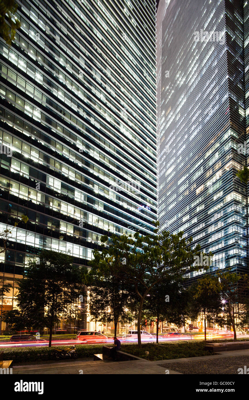 Trailing lights from vehicles among high rise commercial buildings in ...