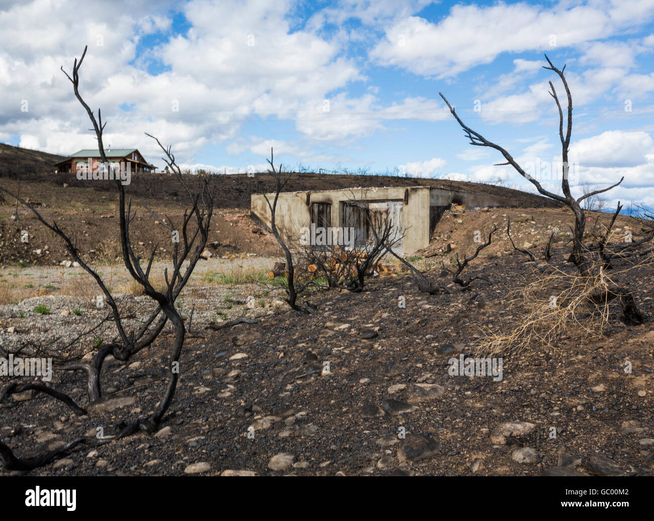Remains of a burned house home in charred rural landscape after a fire ...