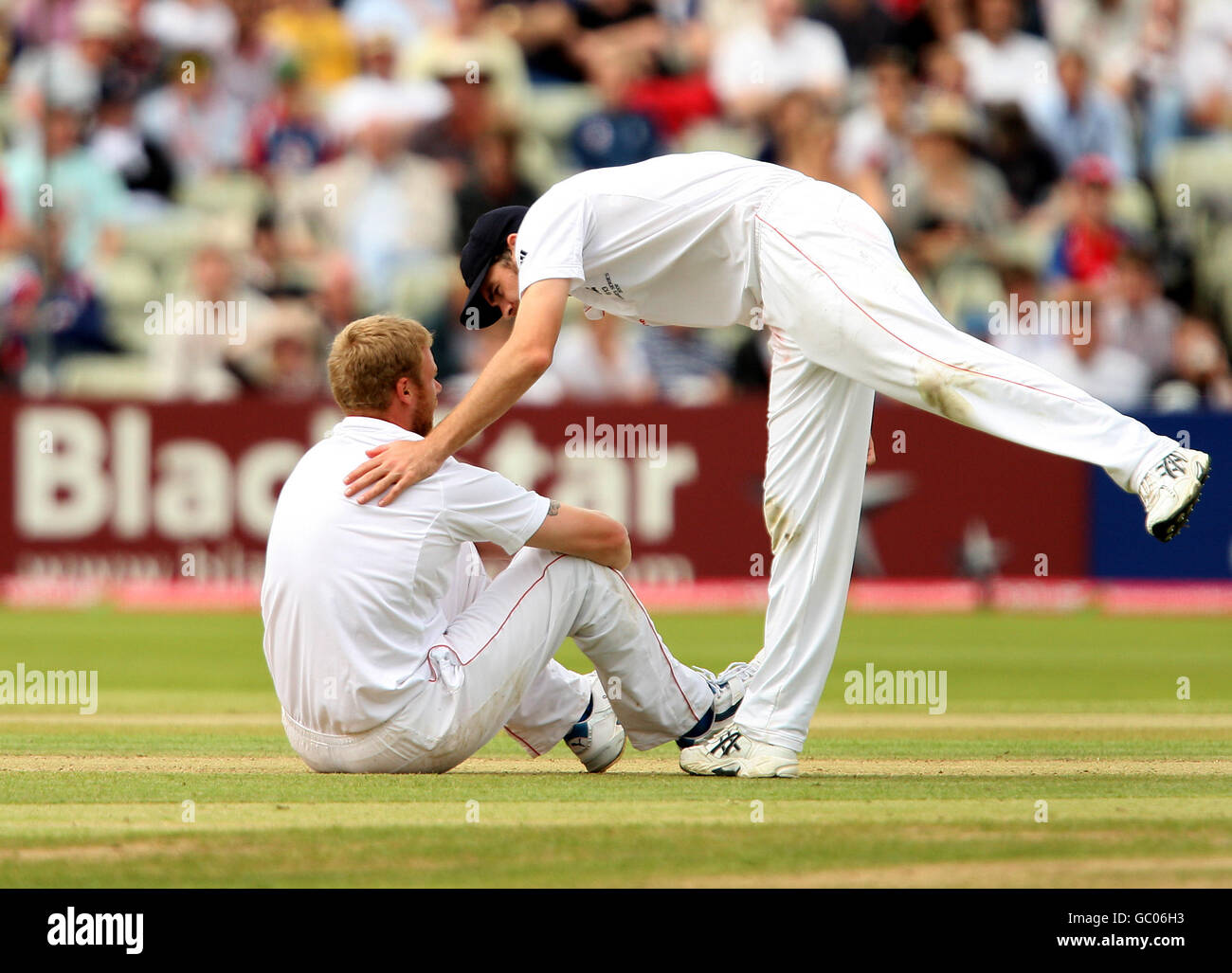 England's Andrew Flintoff sits on the floor after falling as team mate ...