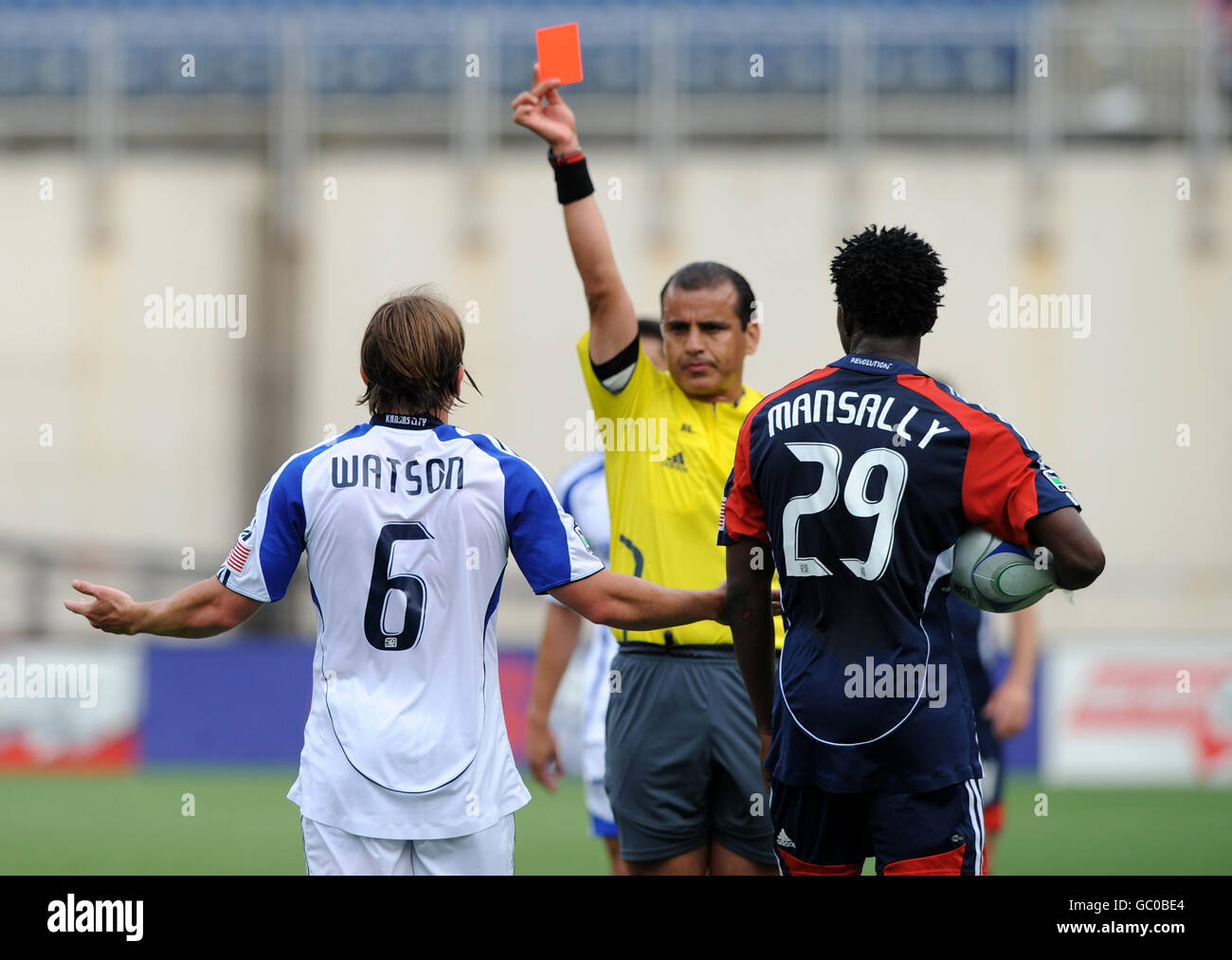 Kansas City Wizards' Lance Watson (left) is shown a red card by referee ...