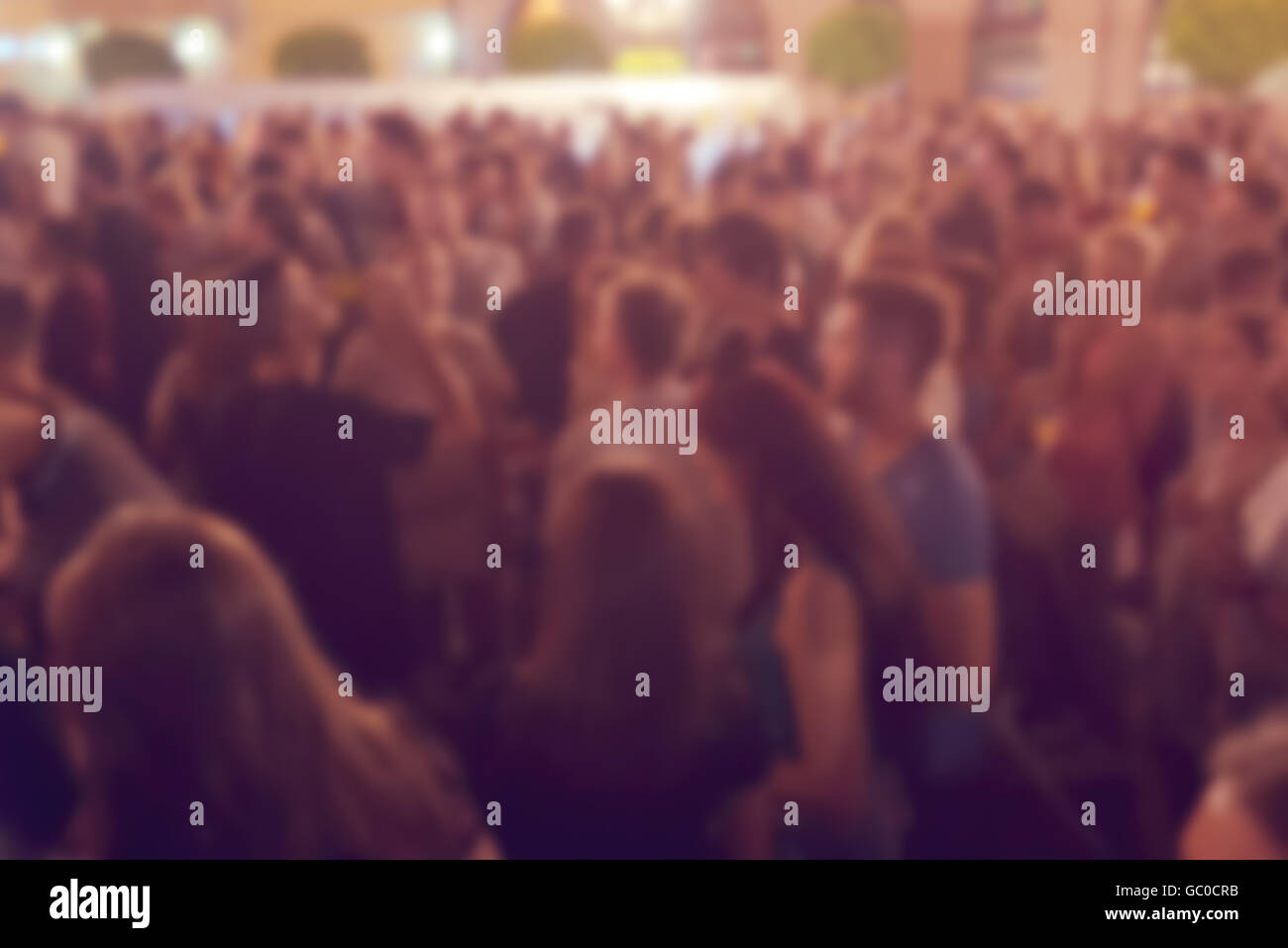 Unrecognizable crowd of young people at outdoor summer night party ...