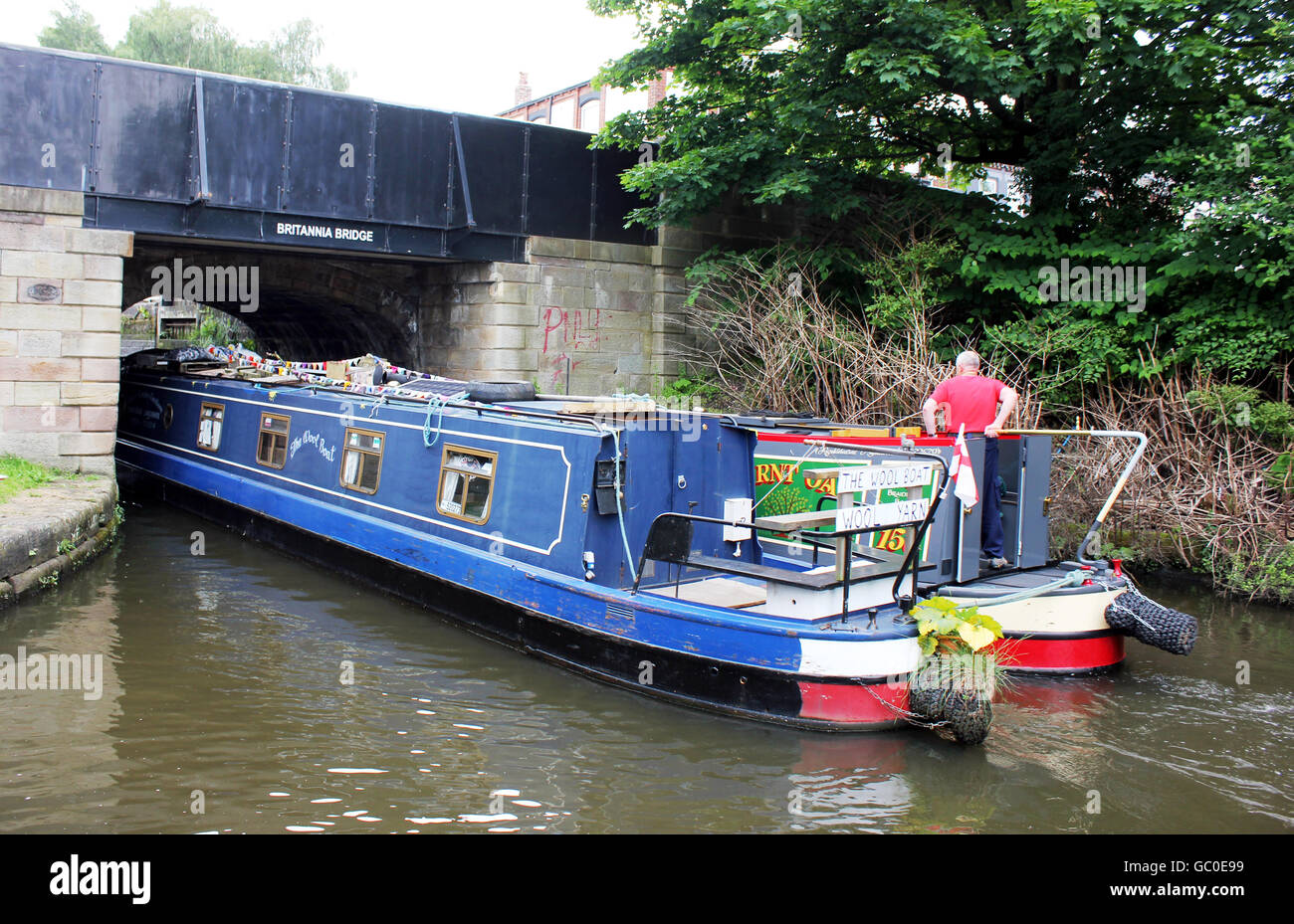 Two narrow boats pass under Britannia bridge on the Leeds and Liverpool ...