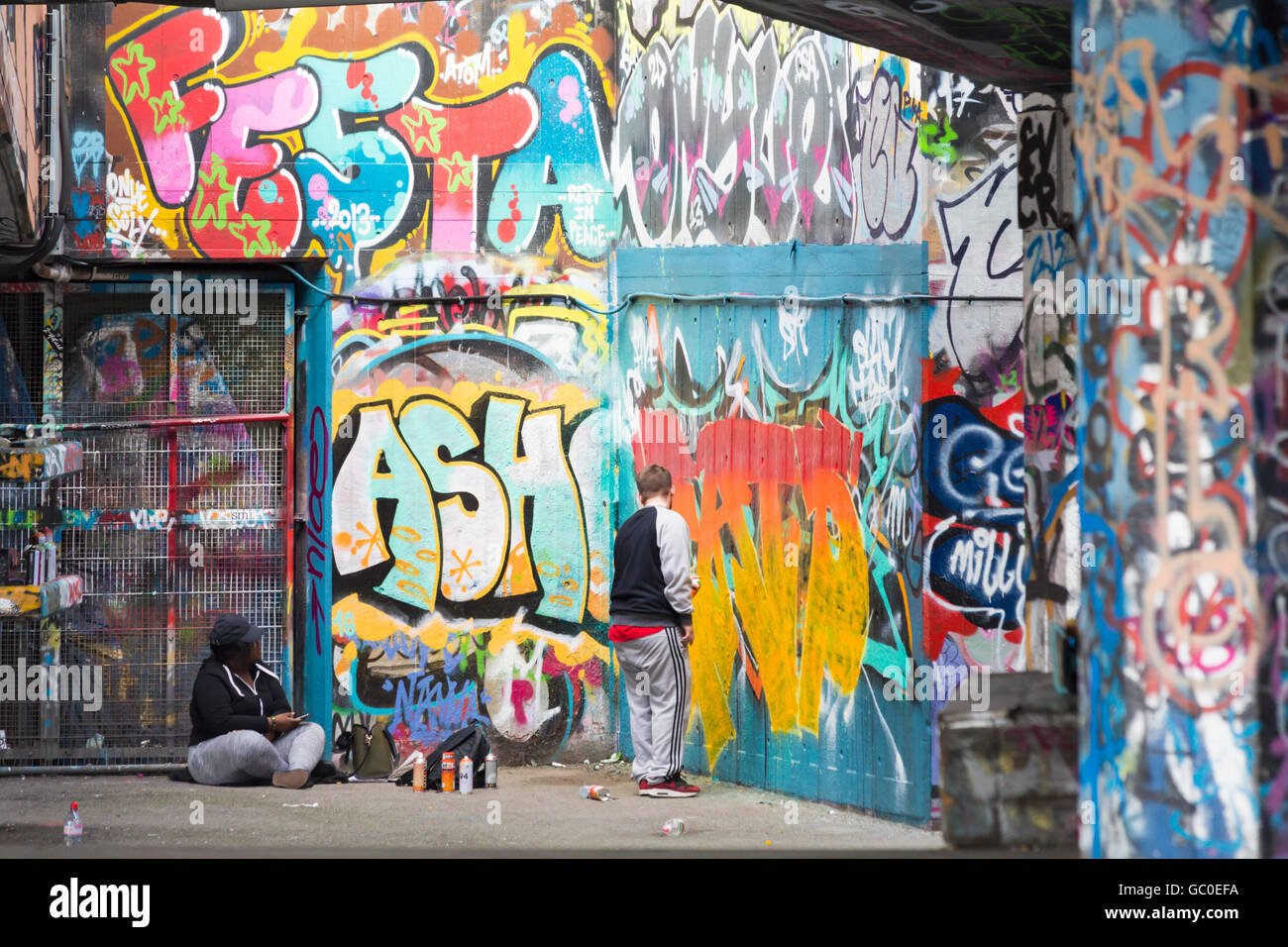 Spraying graffiti at Southbank skate park, London in July Stock Photo ...