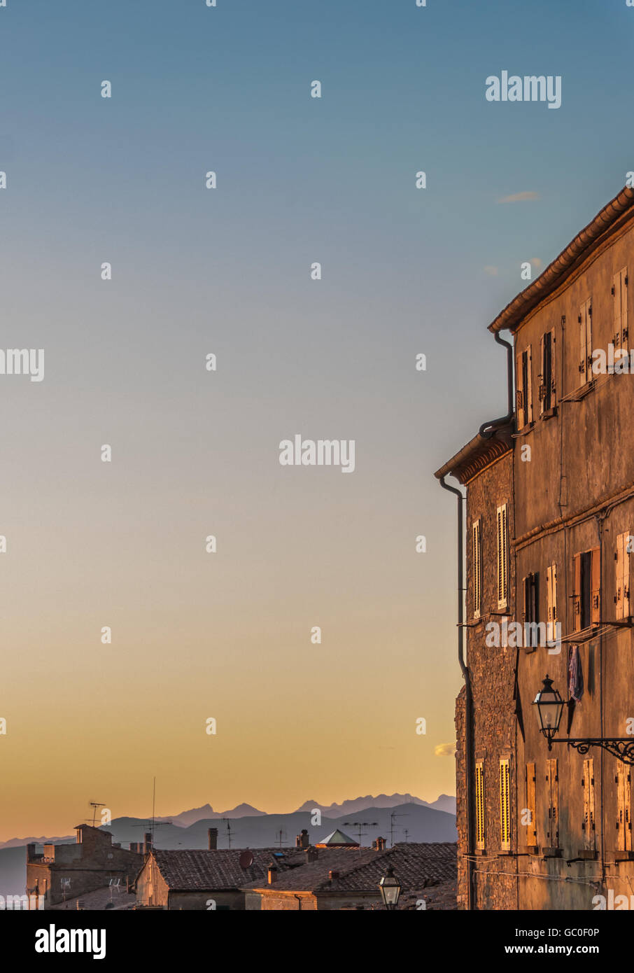Sunset light over old buildings in Volterra, Italy Stock Photo - Alamy