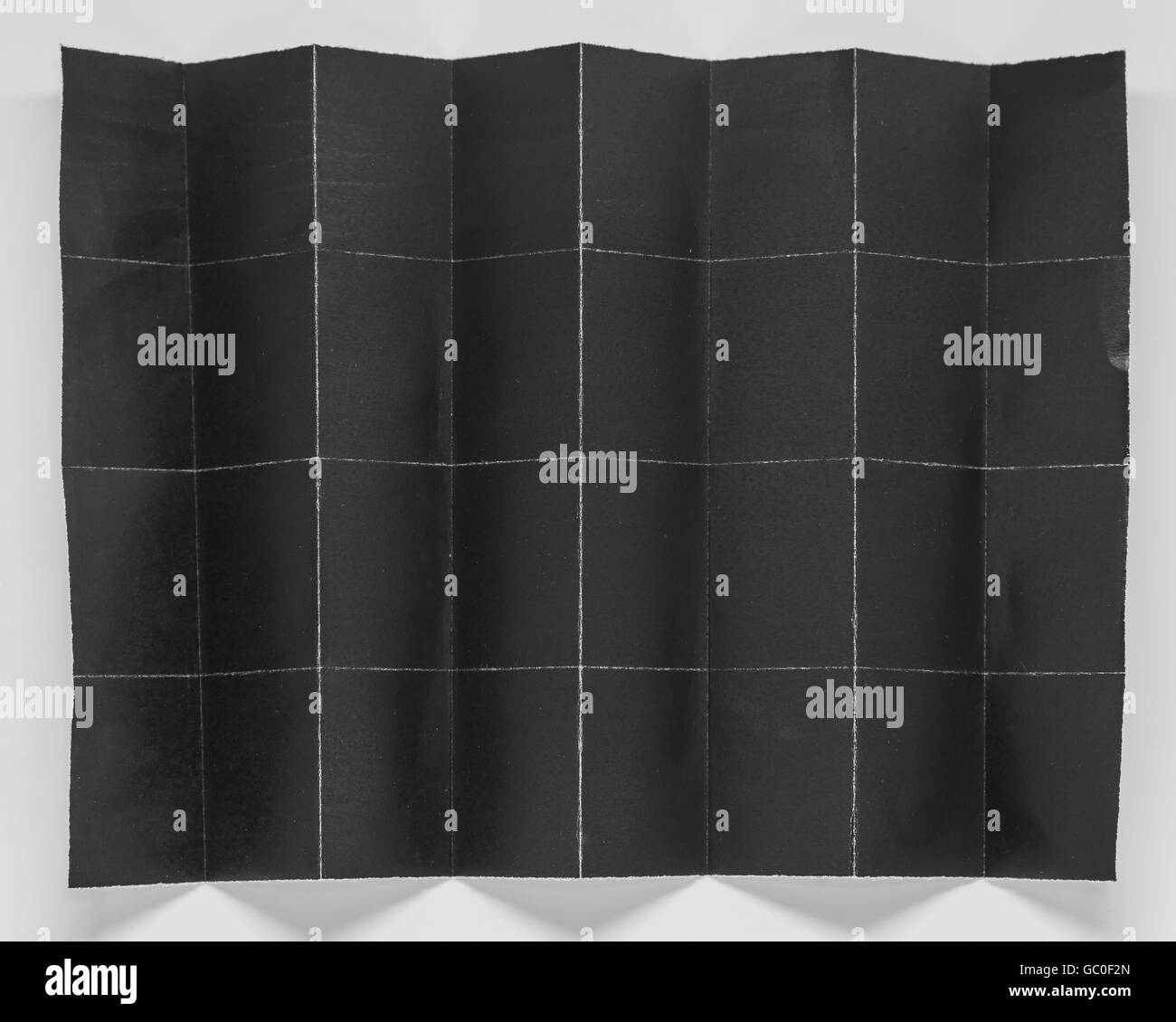 Folded black paper in 32 parts with white background Stock Photo - Alamy