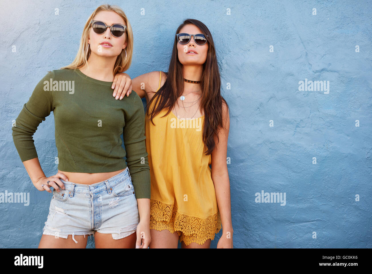 Fashion portrait of two friends posing together. Two stylish female ...