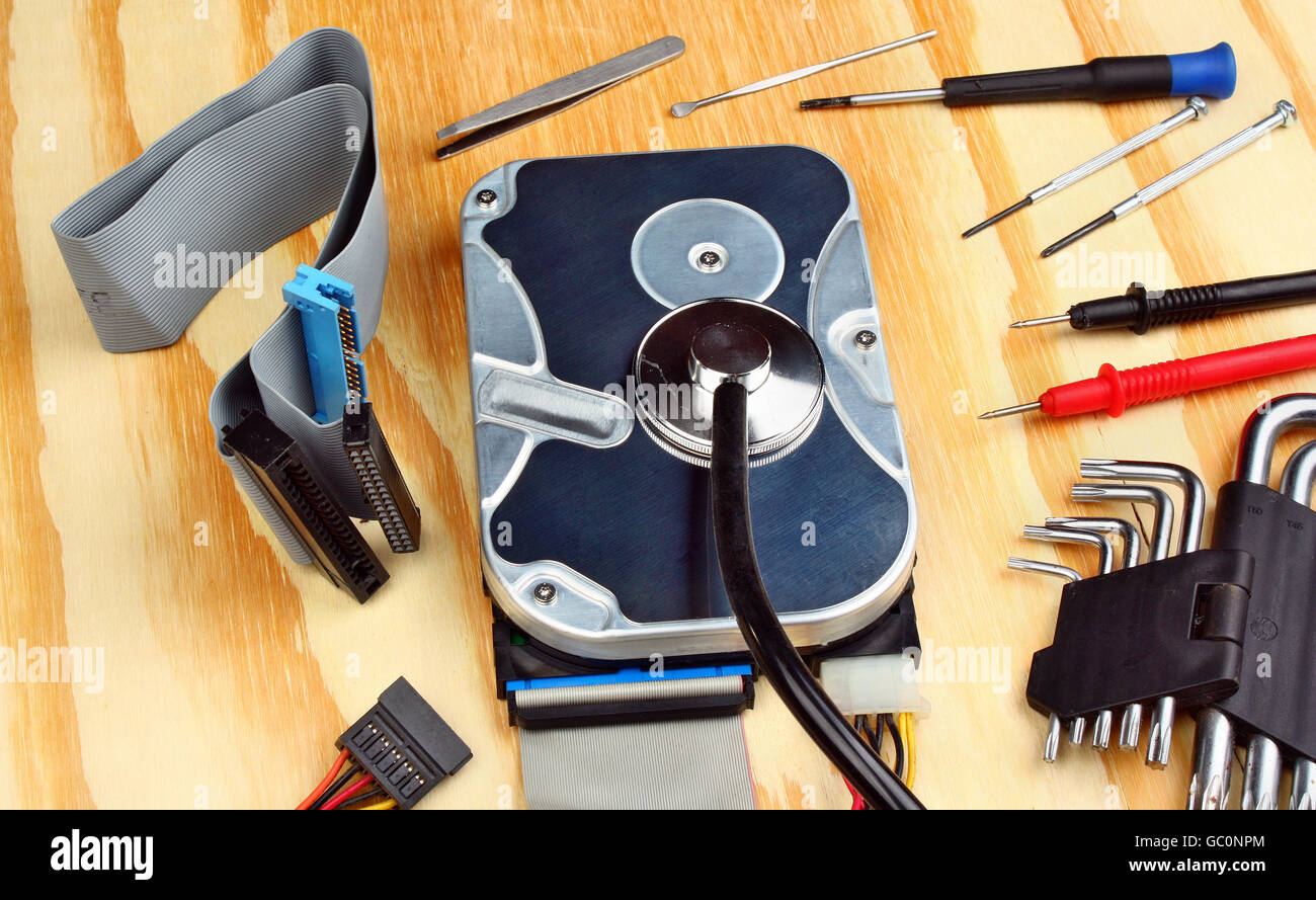 Close up of a computer hard disc on a wooden table Stock Photo - Alamy