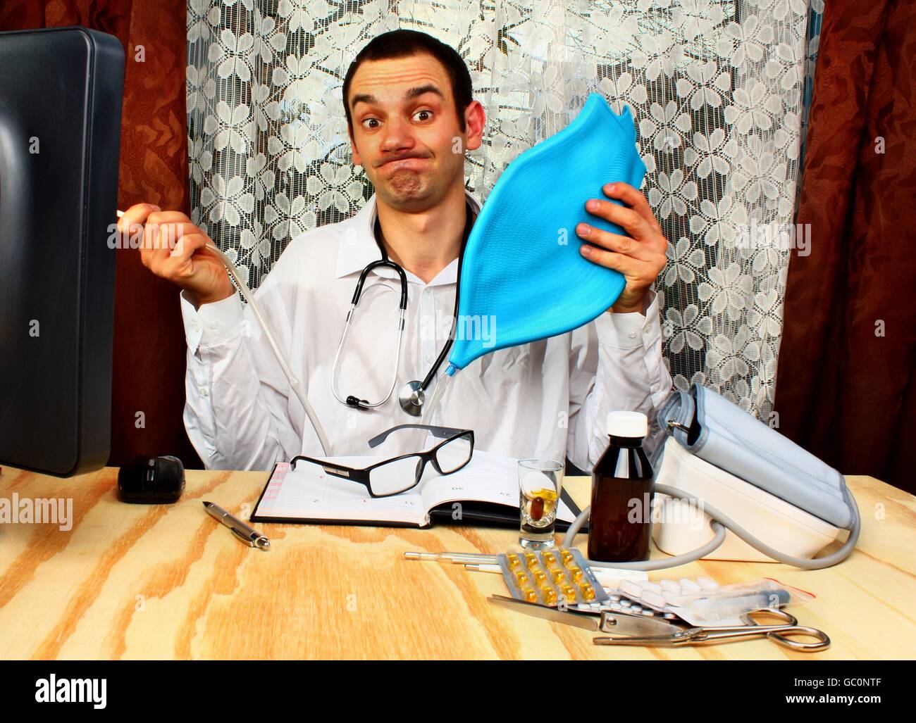 Doctor proctologist is wearing white medicine uniform and holding blue ...