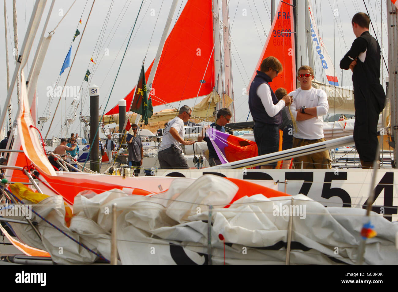 Competitors check their emergency storm sails ahead of the start of the ...