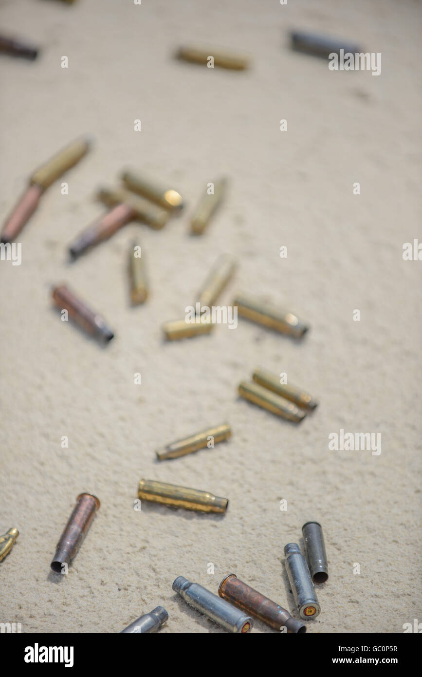 Bullets and spent cases on sand from hand gun Stock Photo - Alamy