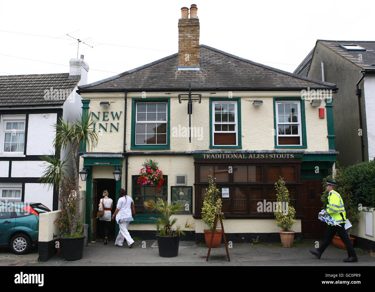 A police officer walks towards The New Inn public House on Myrtle Road ...