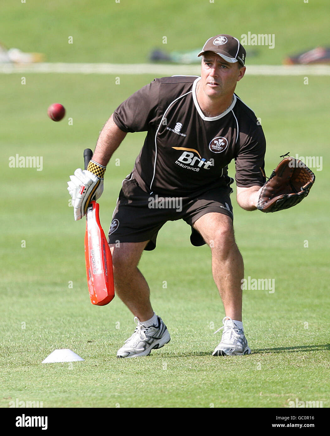 Surrey coach Graham Thorpe gives fielding practice to the players ...