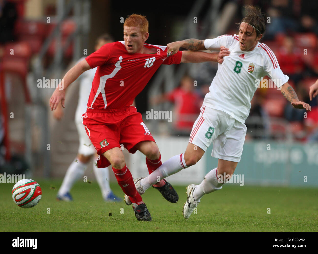 Wales U21's Marc Williams (left) holds off a challenge from Hungary U21 ...