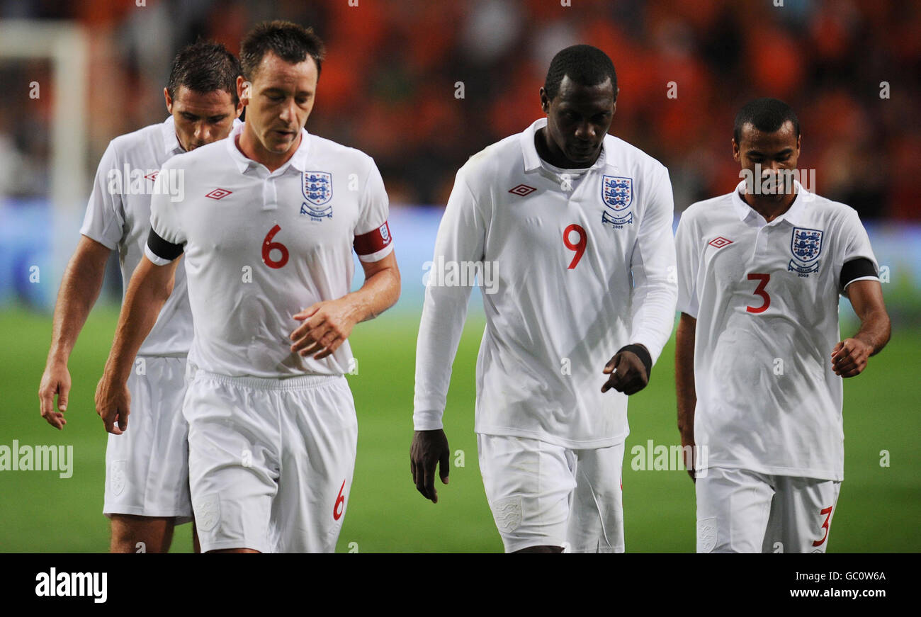 England's (from left) John Terry, Emile Heskey and Ashley Cole walk off ...