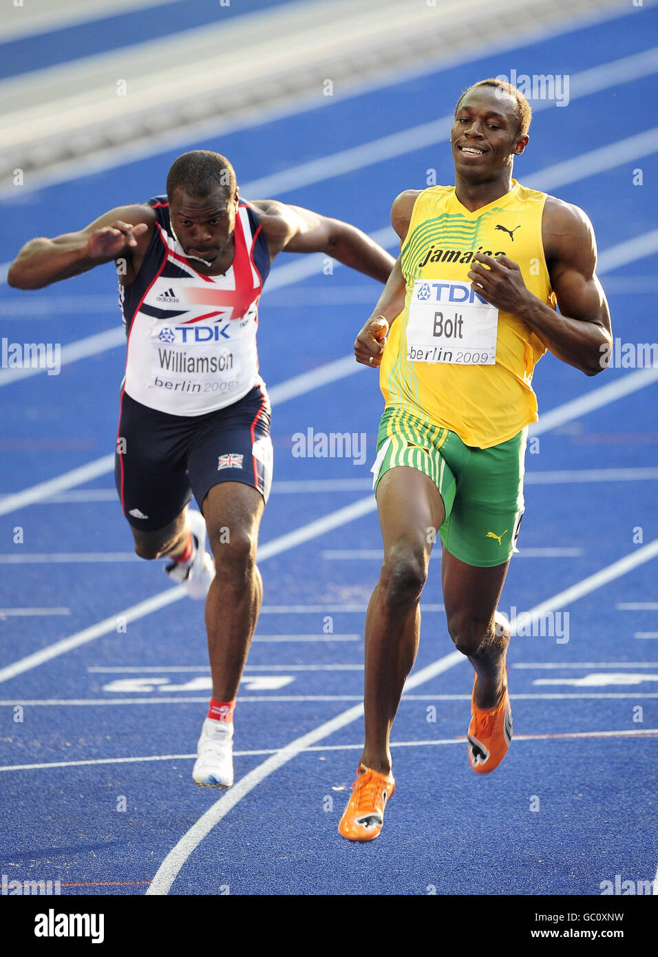 Jamaica's Usain Bolt (right) smiles as he passes Great Britain's ...