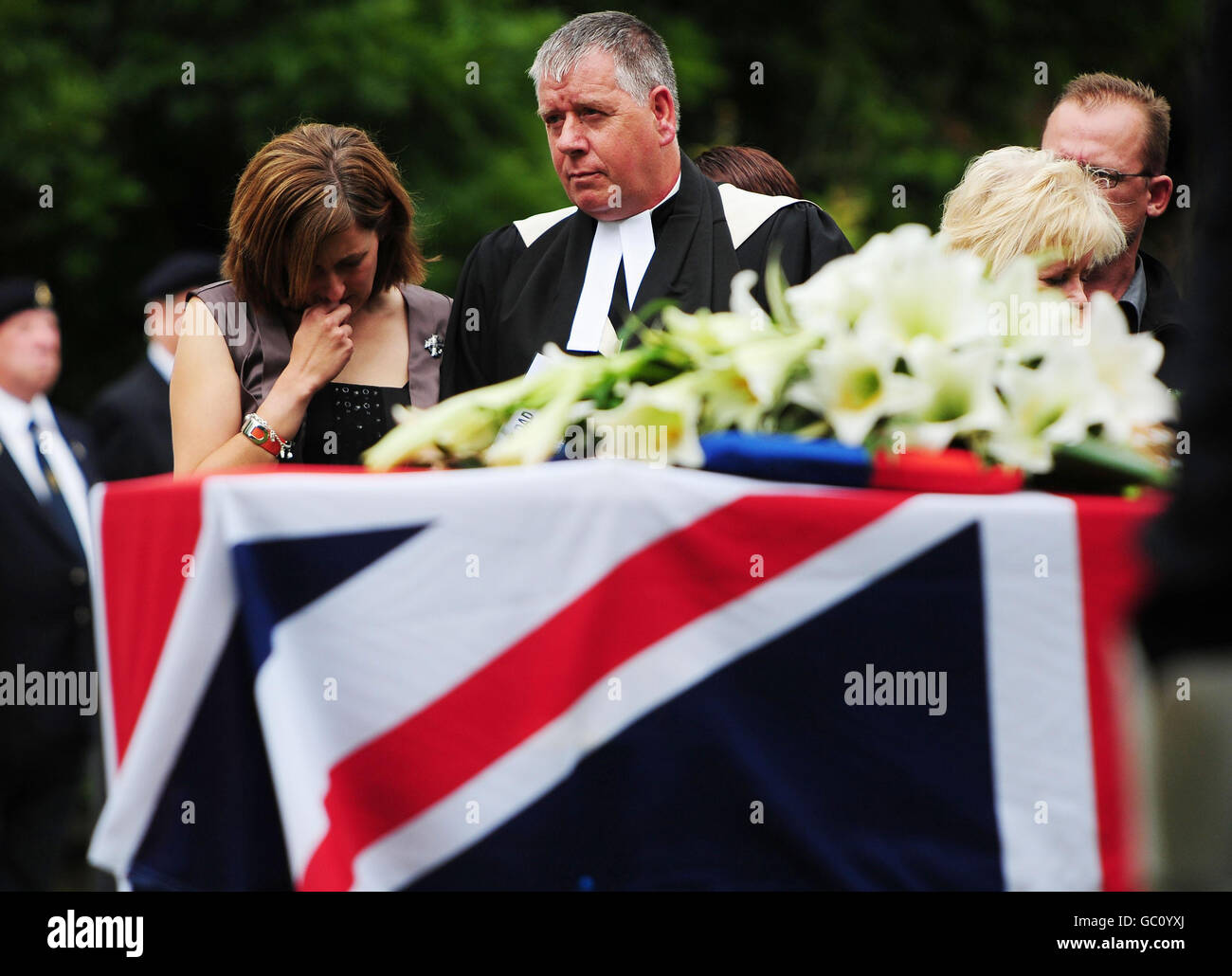Karen Upton, the wife of Warrant Officer Sean Upton, watches his coffin ...