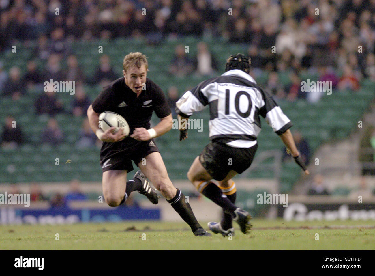 New Zealand's Jimmy Cowan takes on Barbarians' Matt Giteau Stock Photo ...