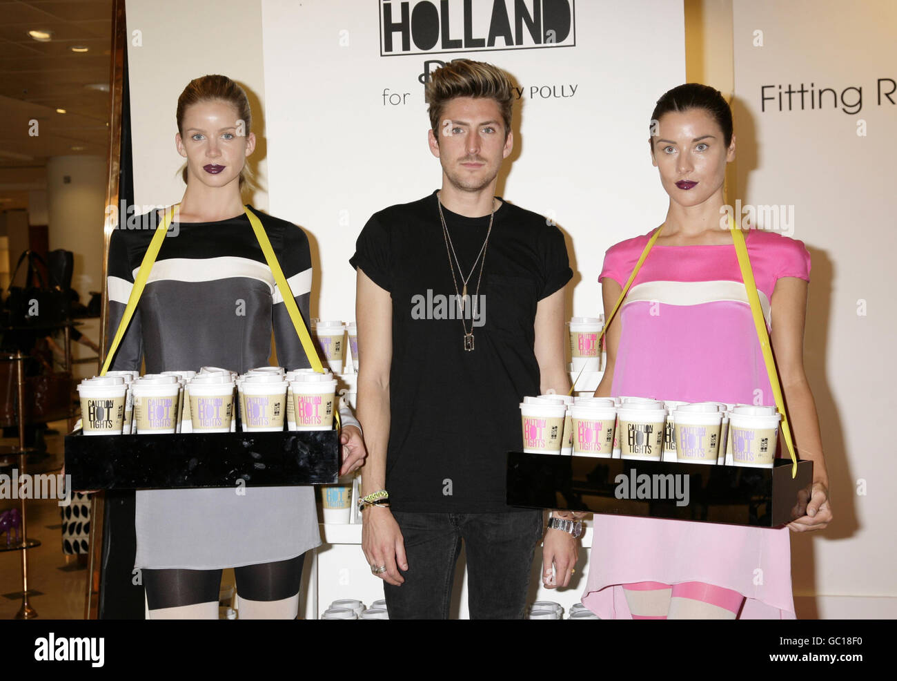 Designer Henry Holland poses with models during a photocall for the ...