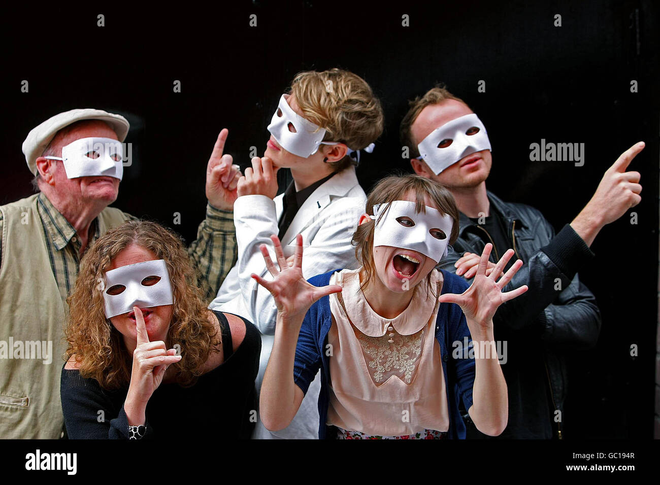 Masked, anonymous individuals attend a photocall to launch the 'Culture ...