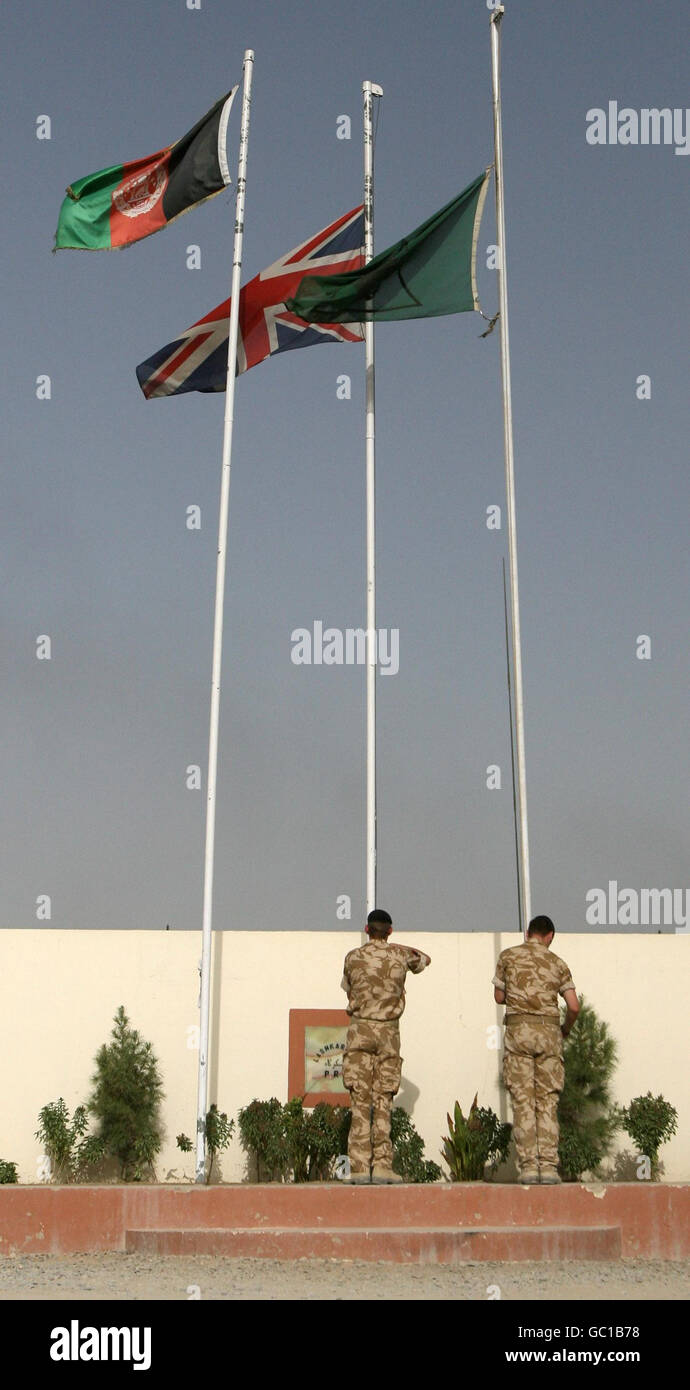Soldiers lower The Union flag and the 19 Light Brigade flag (right) to ...
