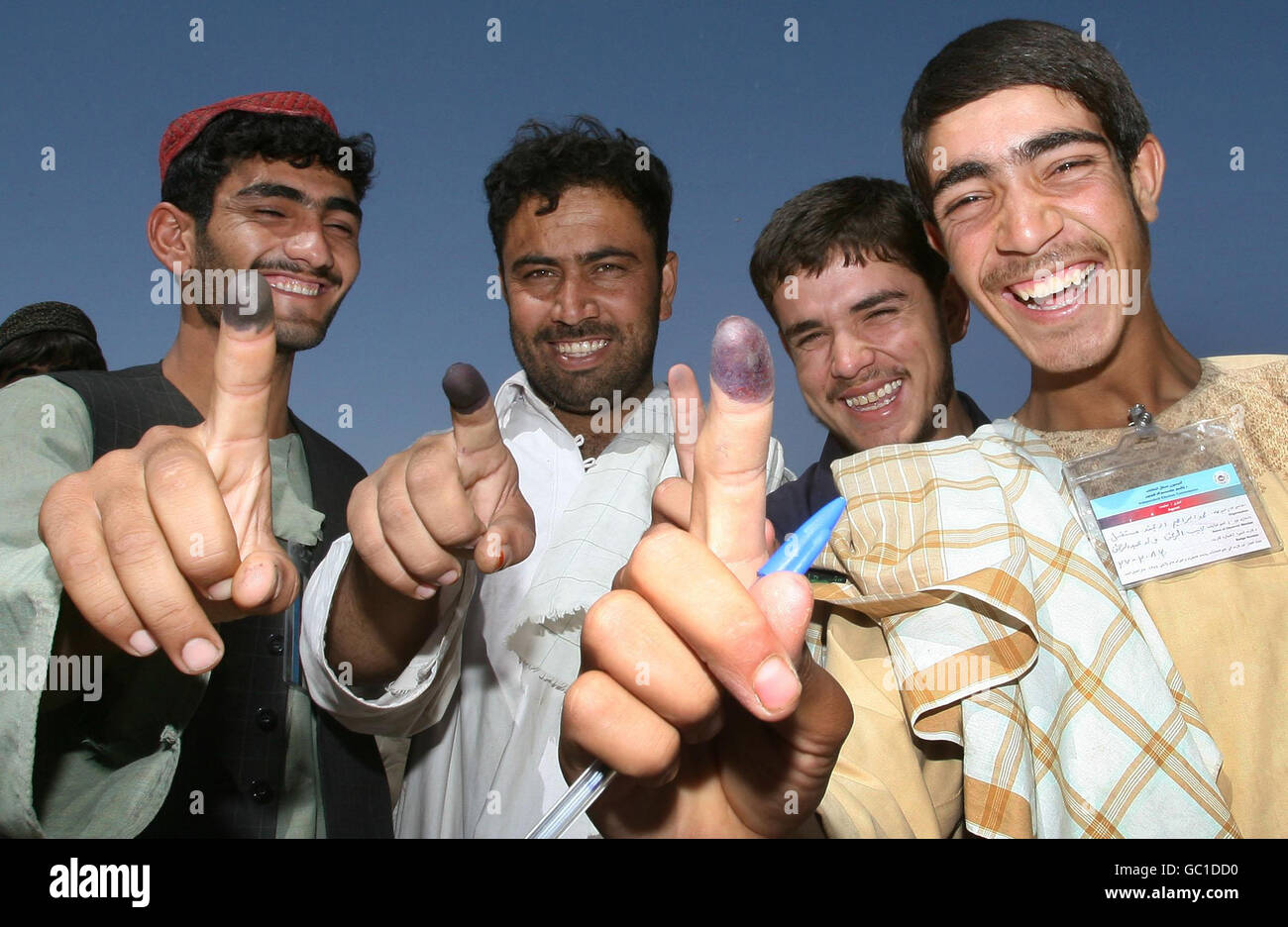 Voters show off their inked fingers after voting in Afghanistan's ...