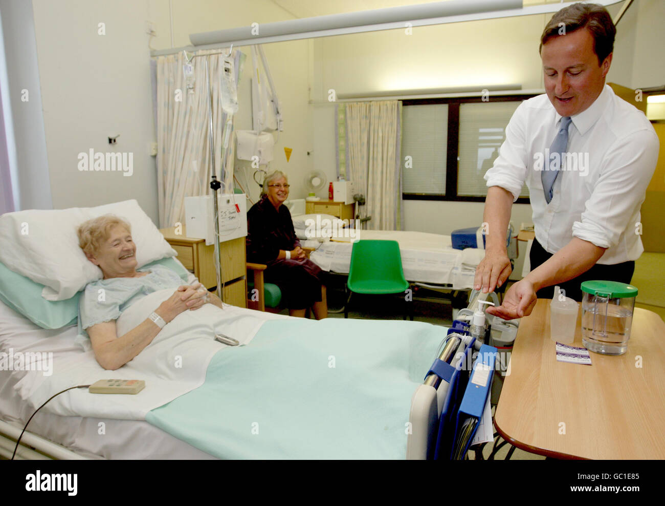 Conservative Party leader David Cameron cleans his hands with alcohol ...