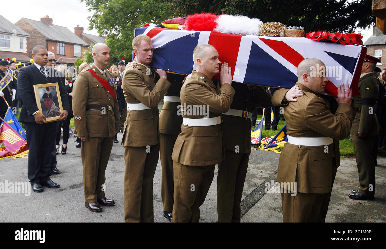The coffin of Fusilier Simon Annis, 22, is carried into the church of ...