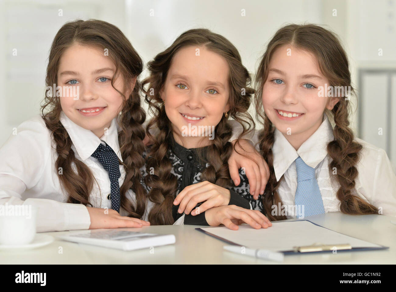Three little girls making homework Stock Photo - Alamy