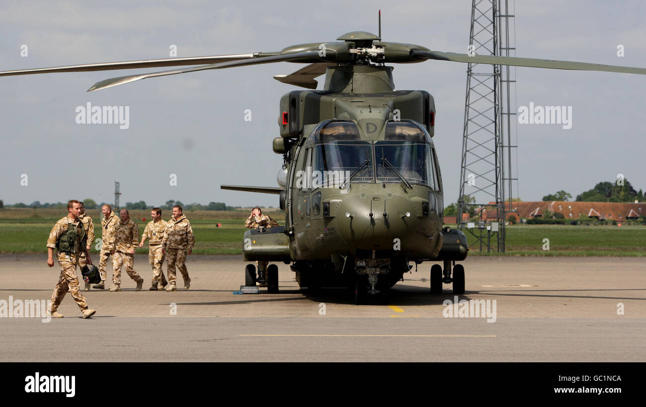 Personnel disembark, as the last two Merlin helicopters return from ...
