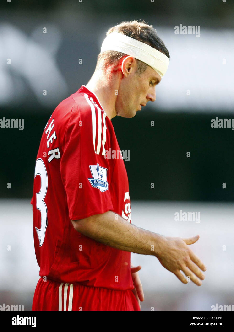 Liverpool's Jamie Carragher wears a head bandage during the Barclays ...