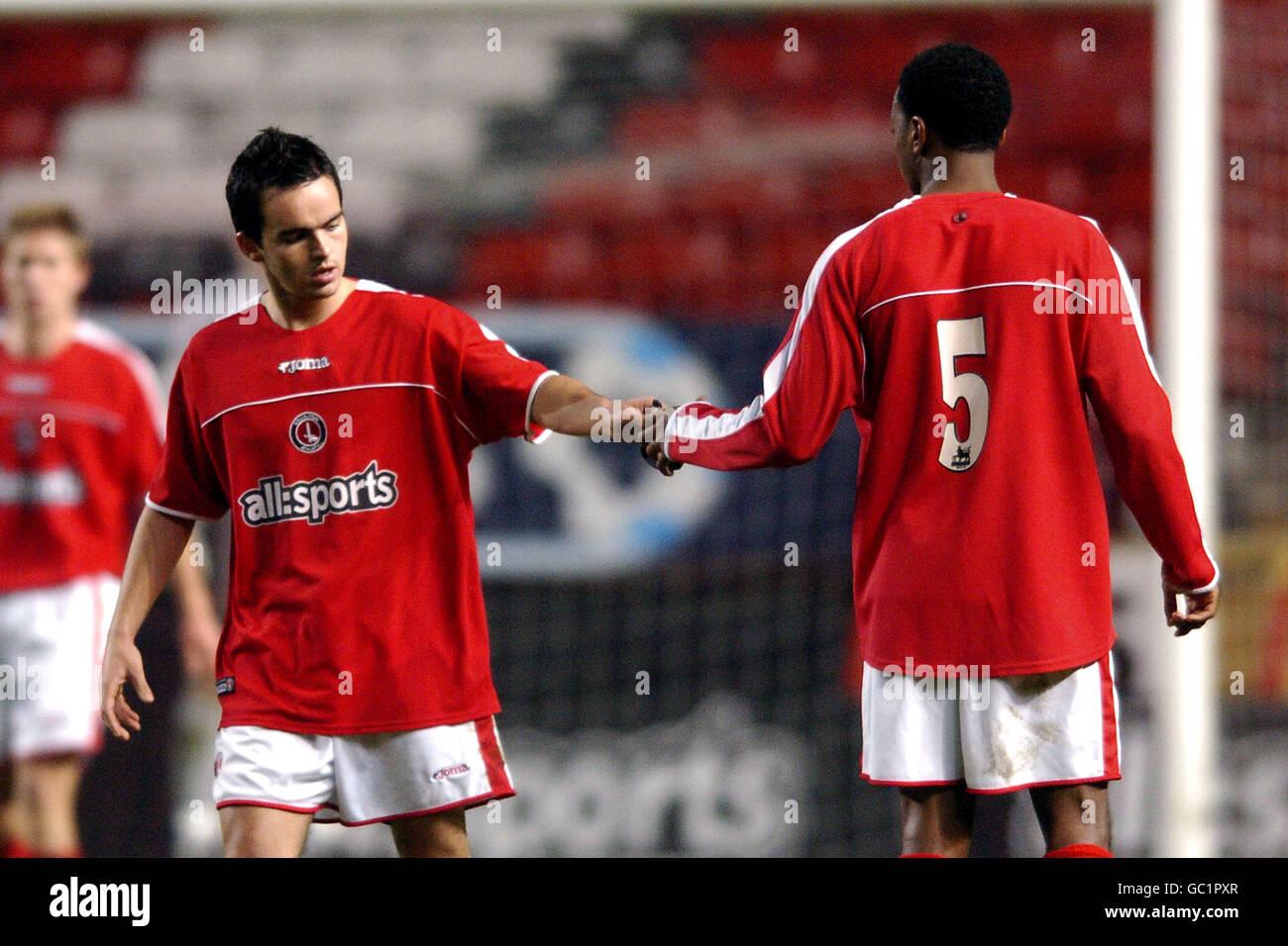 Charlton Athletic's Neil McCafferty (l) passes the captain's armband ...