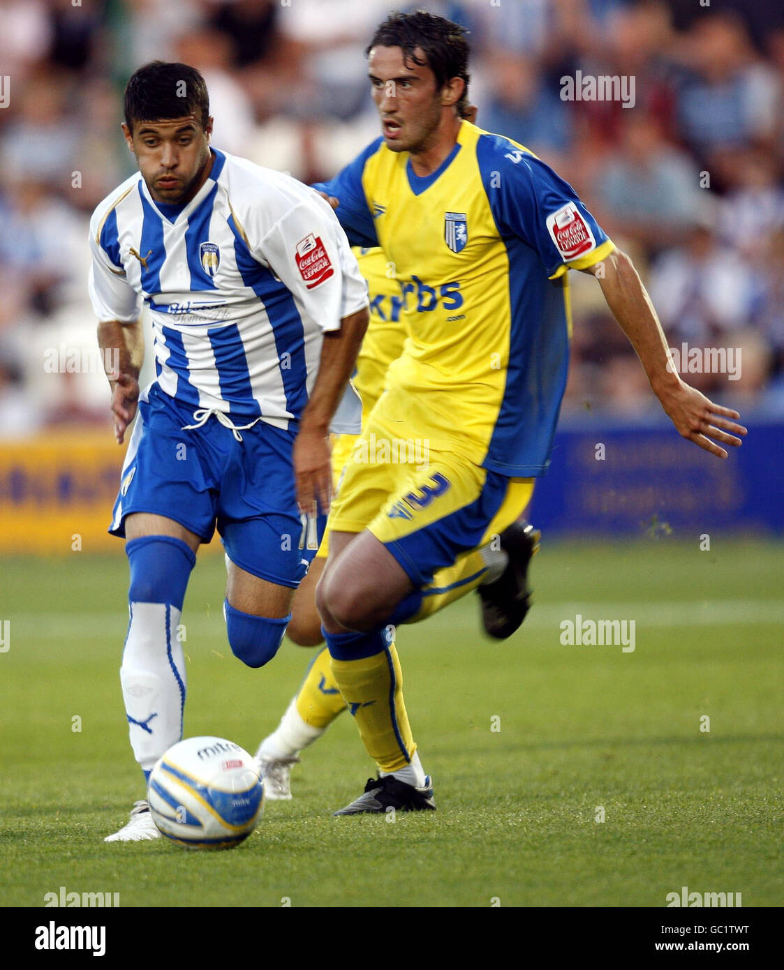 Colchester's Simon Hackney (left) and Gillingham's John Nutter battle ...