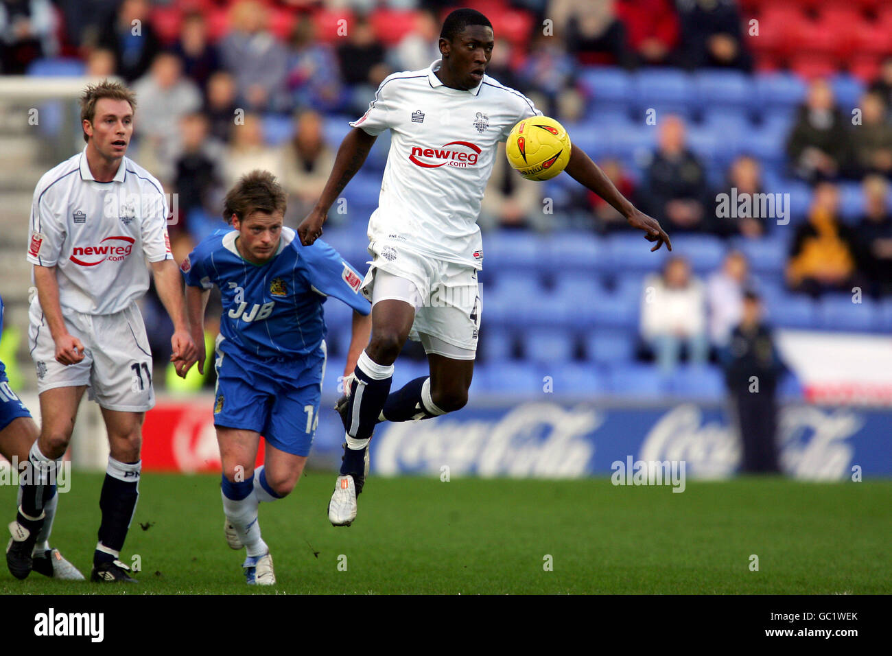 Preston North End's Dickson Etuhu gets away from Wigan's Nicky Eadan ...