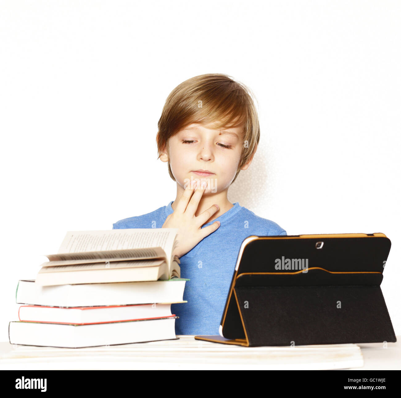 cute young boy with books and electronic tablet Stock Photo - Alamy