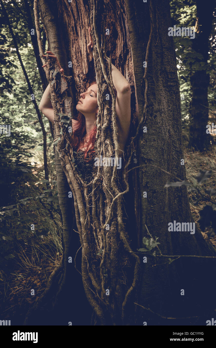 A Young Red Haired Redhead Woman Girl Alone In A Forest Entwined In The Vines Surrounding A