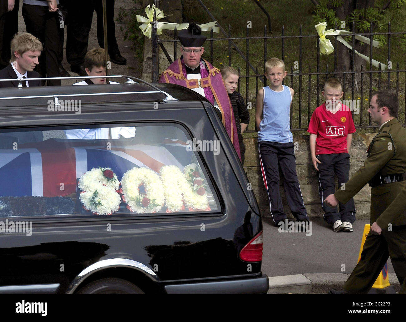 A hearse carries the coffin of Rifleman Daniel Wild during the funeral ...