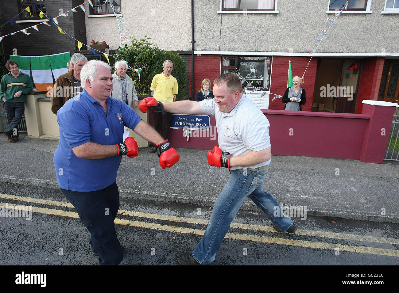 Locals shadow boxing on Turnpike road as they wait for boxing legend ...