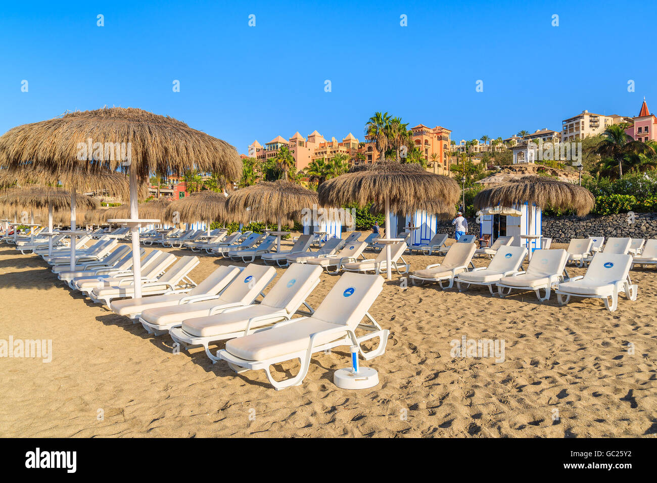 COSTA ADEJE BEACH, TENERIFE - NOV 17, 2015: sunbeds on El Duque beach ...