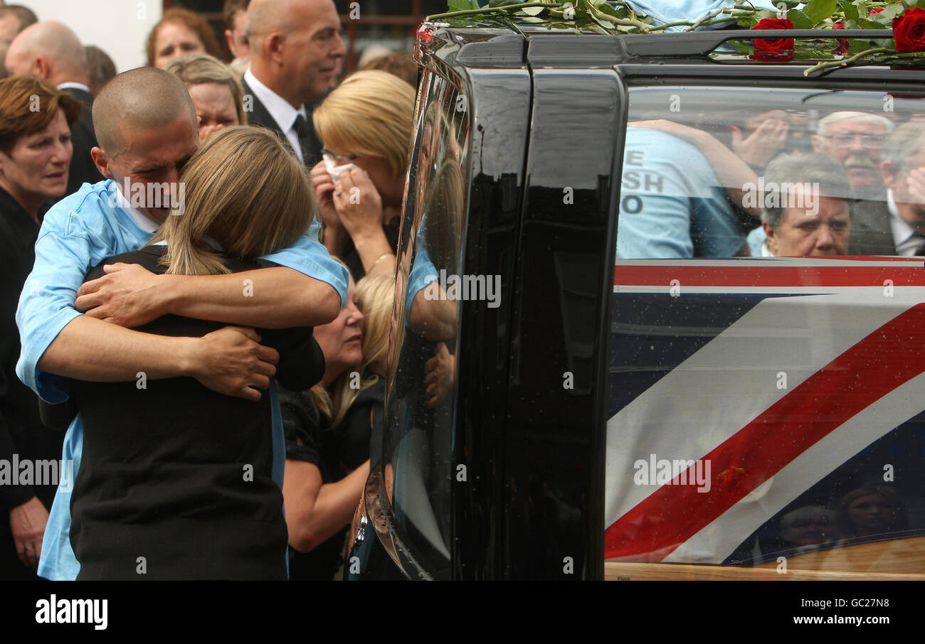 Mourners comfort each other on the streets of Wootton Bassett ...