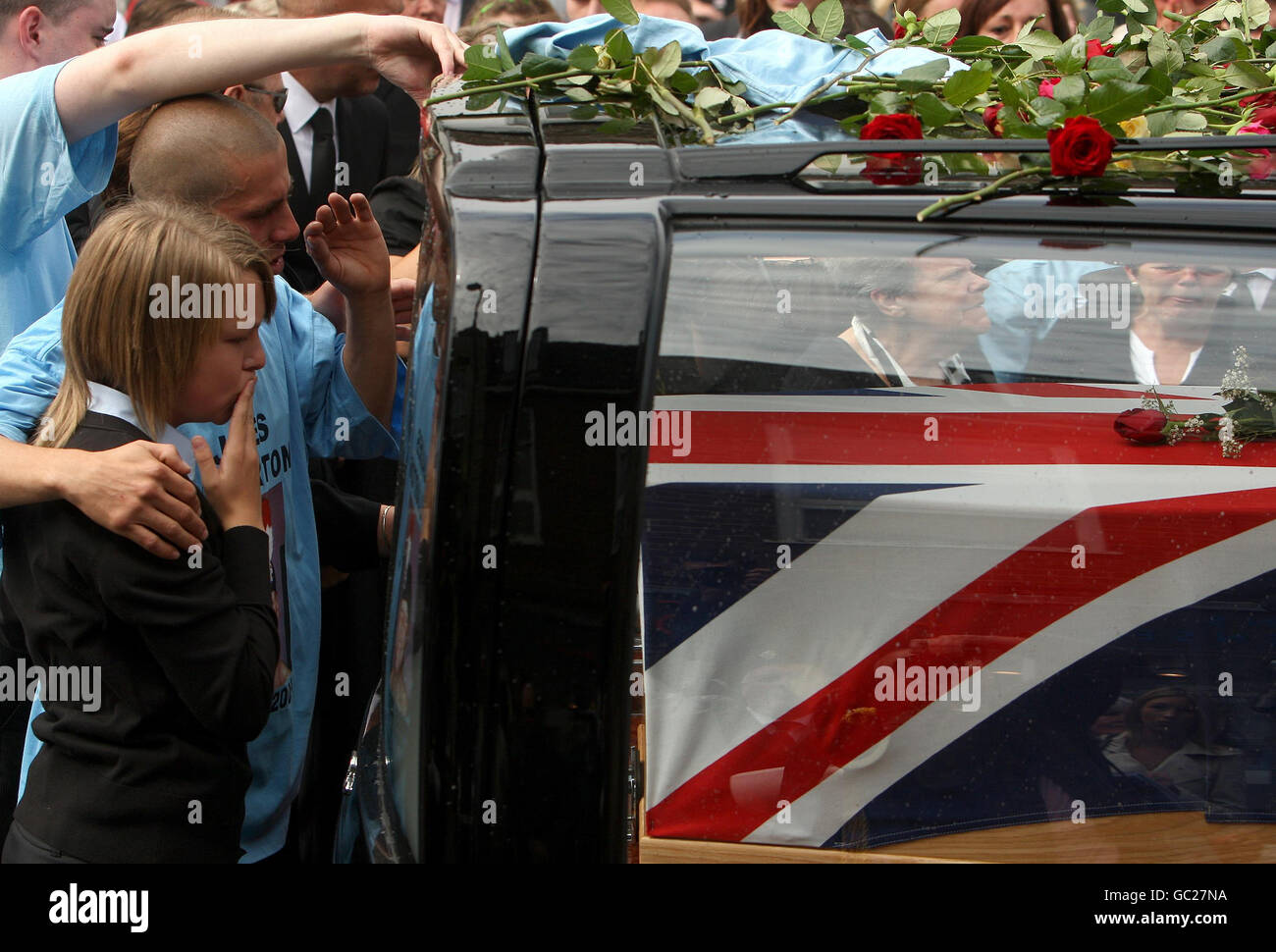 Mourners comfort each other on the streets of Wootton Bassett ...