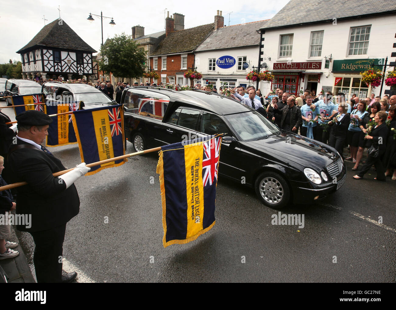 Mourners watch on the streets of Wootton Bassett, Wiltshire, as the ...