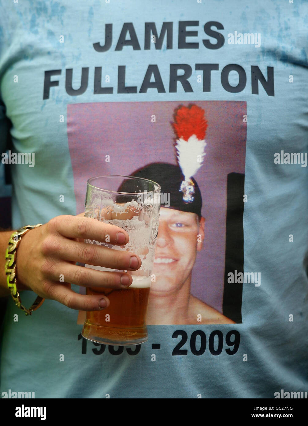 A mourner wears a t-shirt with a picture of Lance Corporal James ...