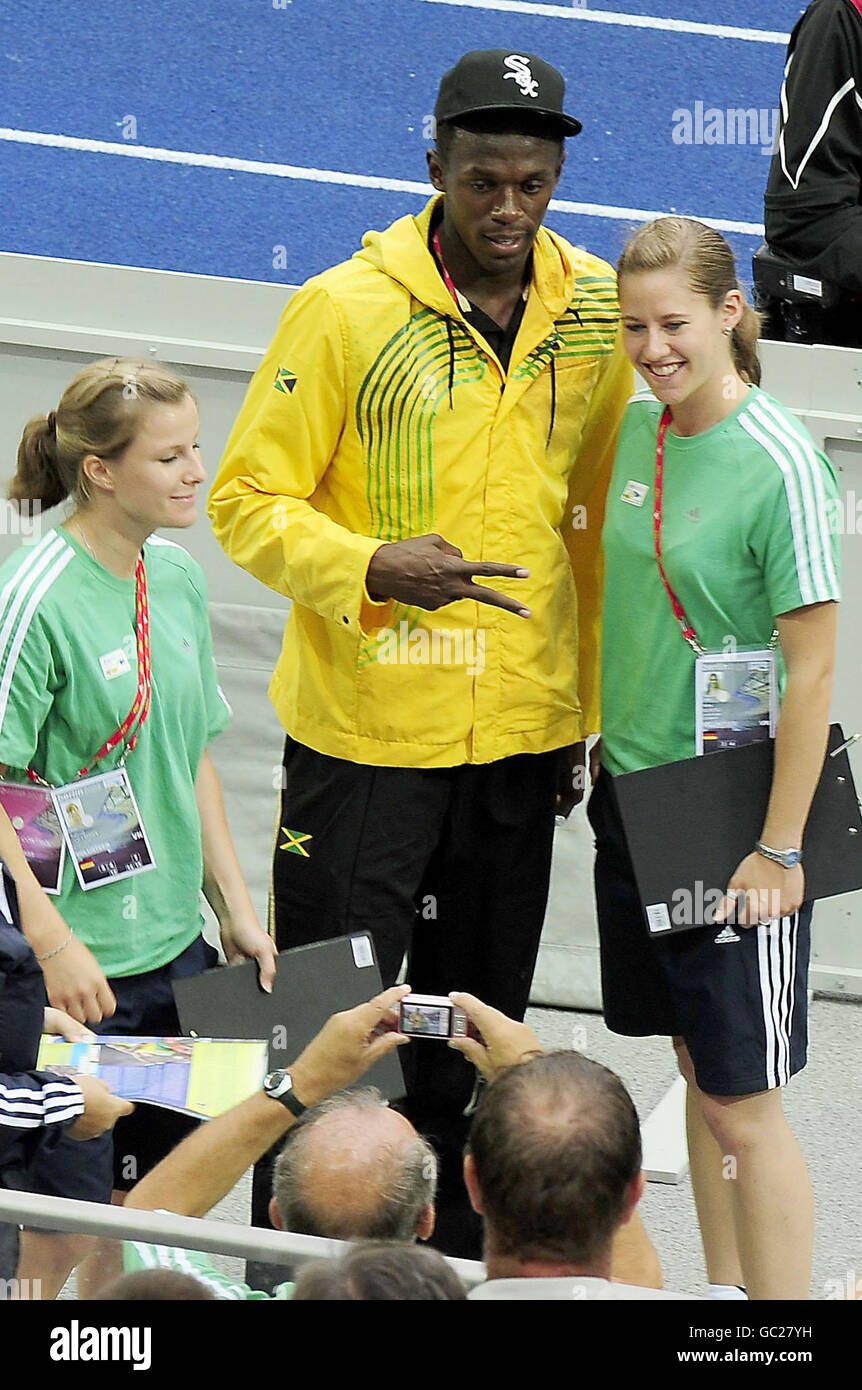Usain Bolt meets members of the crowd as he arrives at the Olympic ...