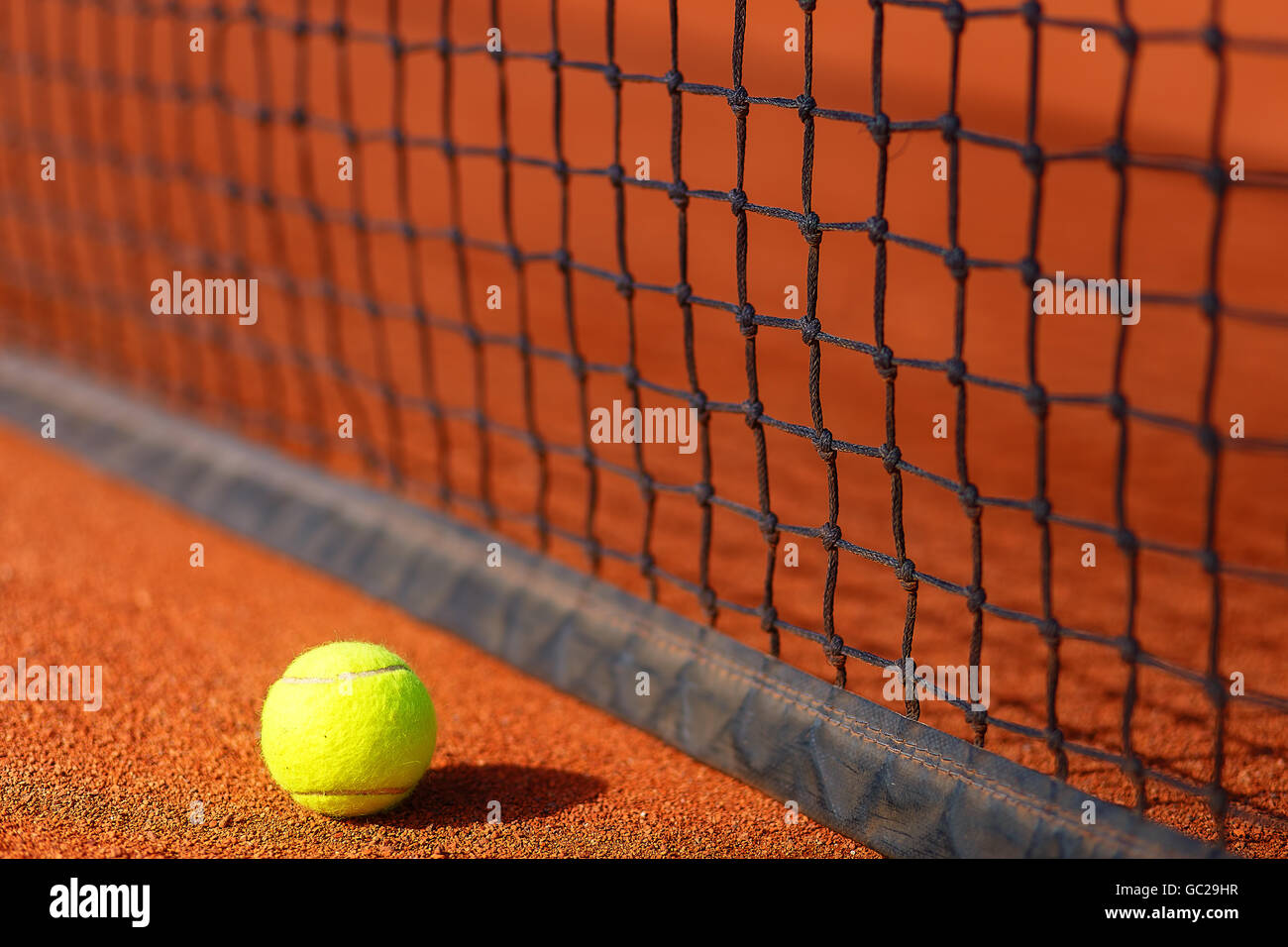 tennis court with tennis ball and antuka background Stock Photo - Alamy
