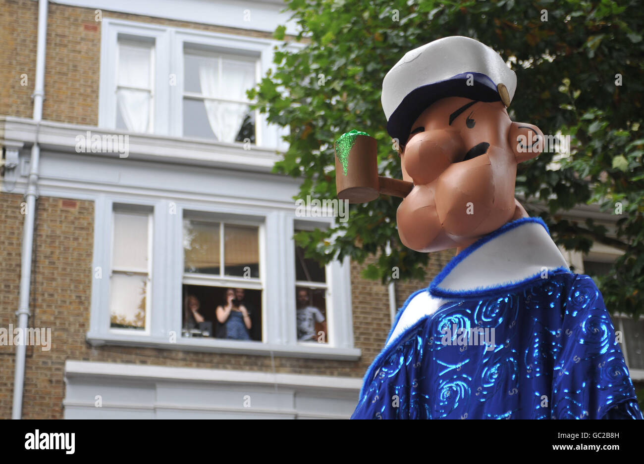A model of cartoon character Popeye parades along the route on the ...