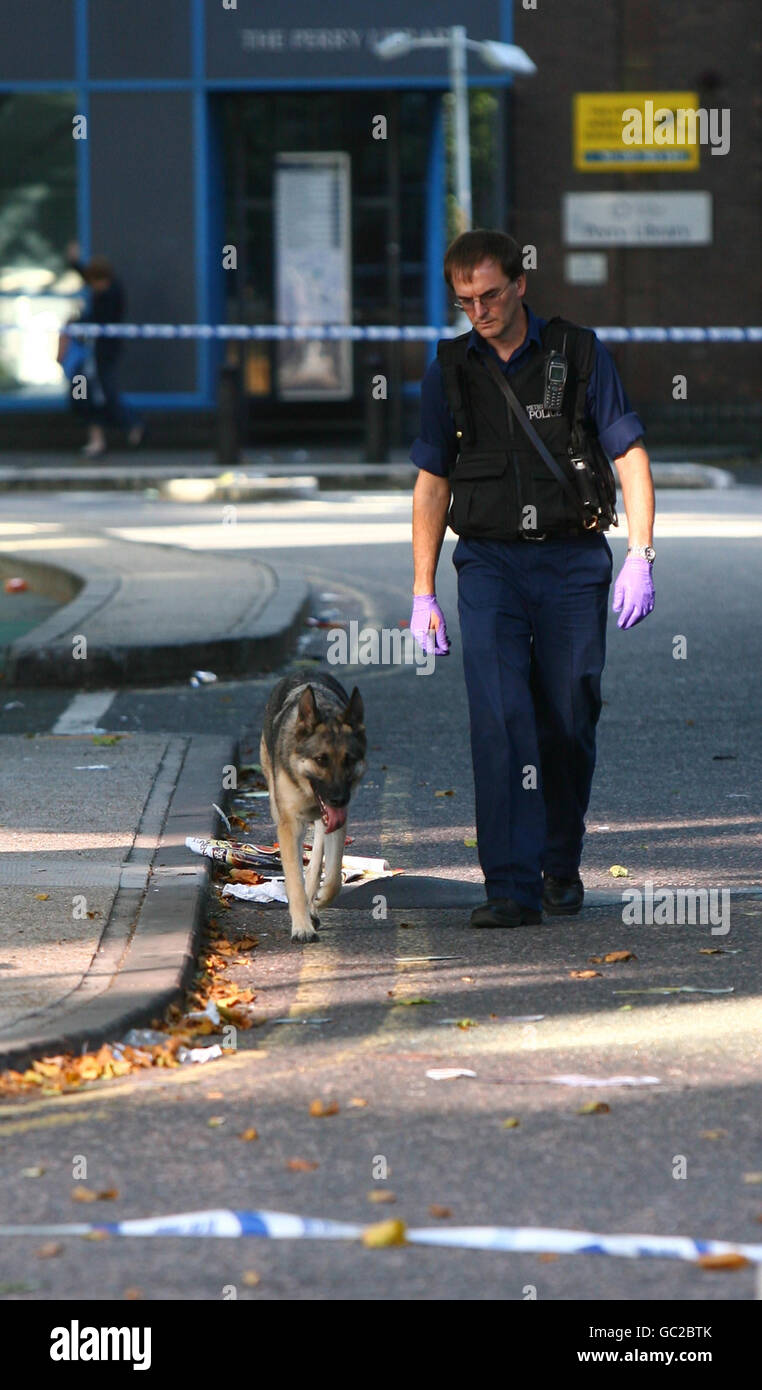 A police officer and his dog search for clues close to Ministry of ...