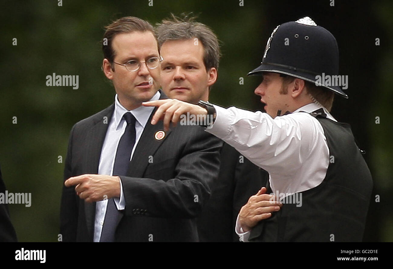 Swedish Finance Minister Anders Borg (left) asks a policeman for ...